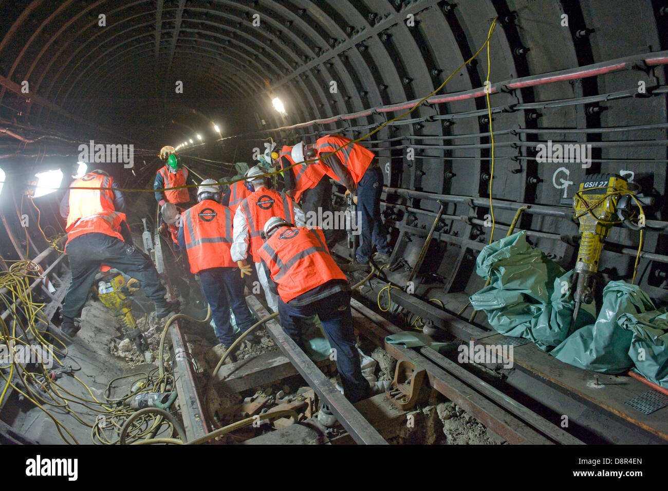 Workers set about digging, bagging up and hauling the old concrete ...