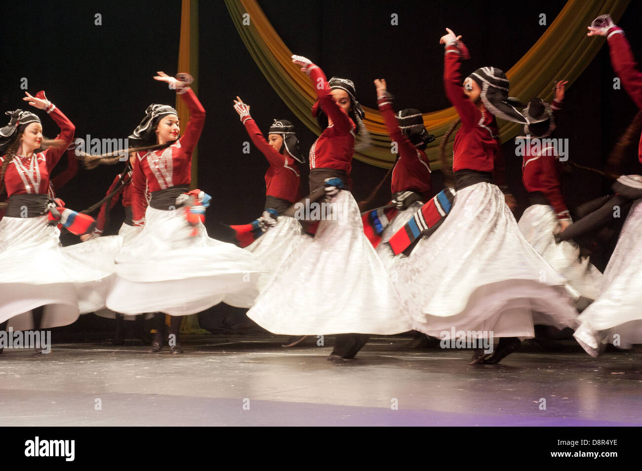 Georgian children dressed with traditional costumes dancing a folklore ...