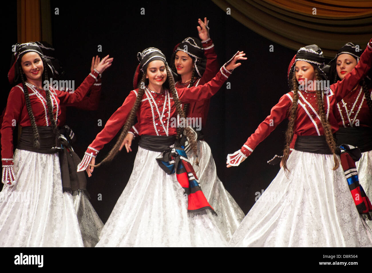 Georgian children dressed with traditional costumes dancing a folklore ...