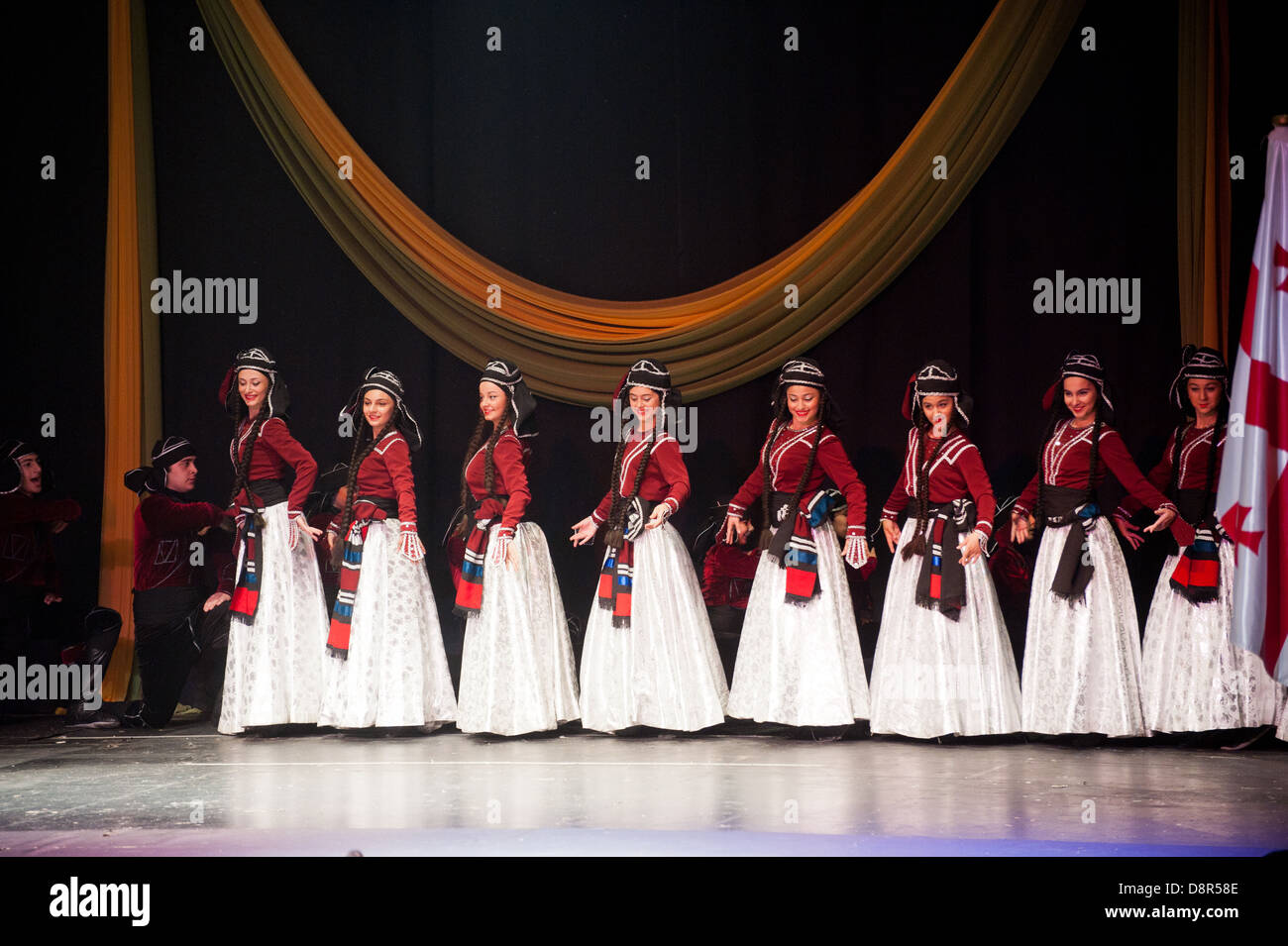 Georgian children dressed with traditional costumes dancing a folklore ...