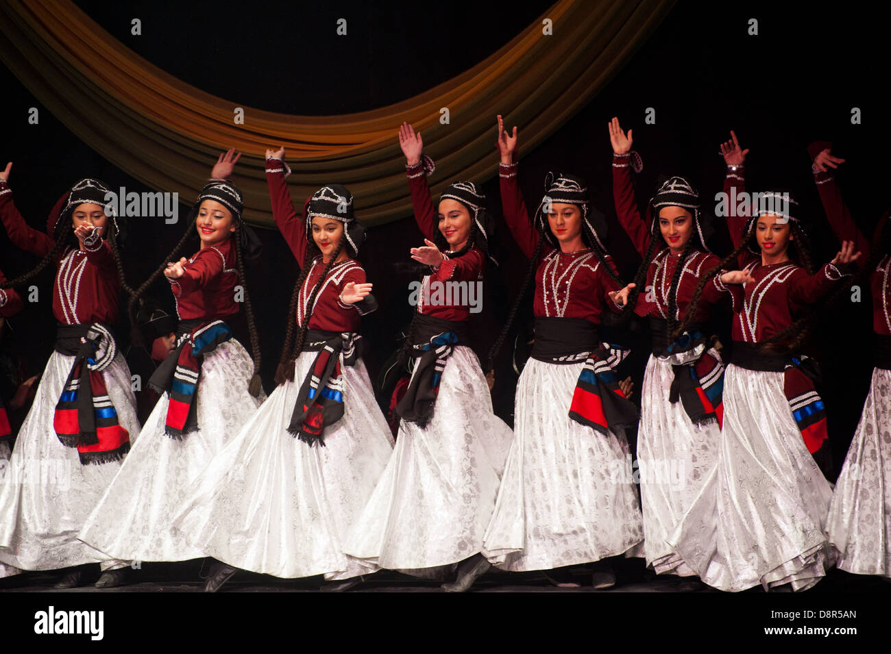 Georgian children dressed with traditional costumes dancing a folklore ...