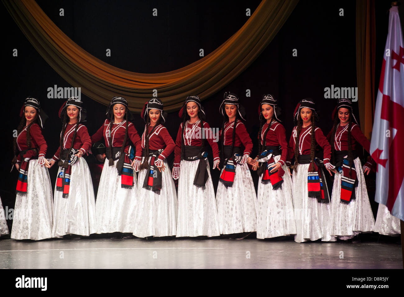 Georgian children dressed with traditional costumes dancing a folklore ...