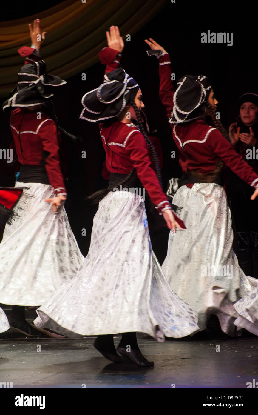 Georgian children dressed with traditional costumes dancing a folklore ...