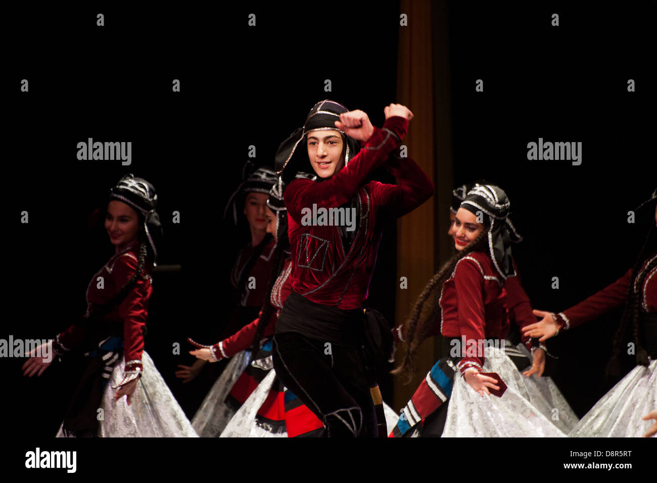 Georgian children dressed with traditional costumes dancing a folklore ...