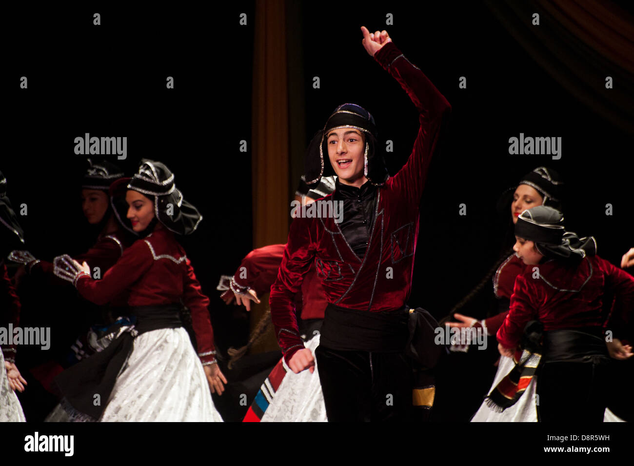 Georgian children dressed with traditional costumes dancing a folklore ...