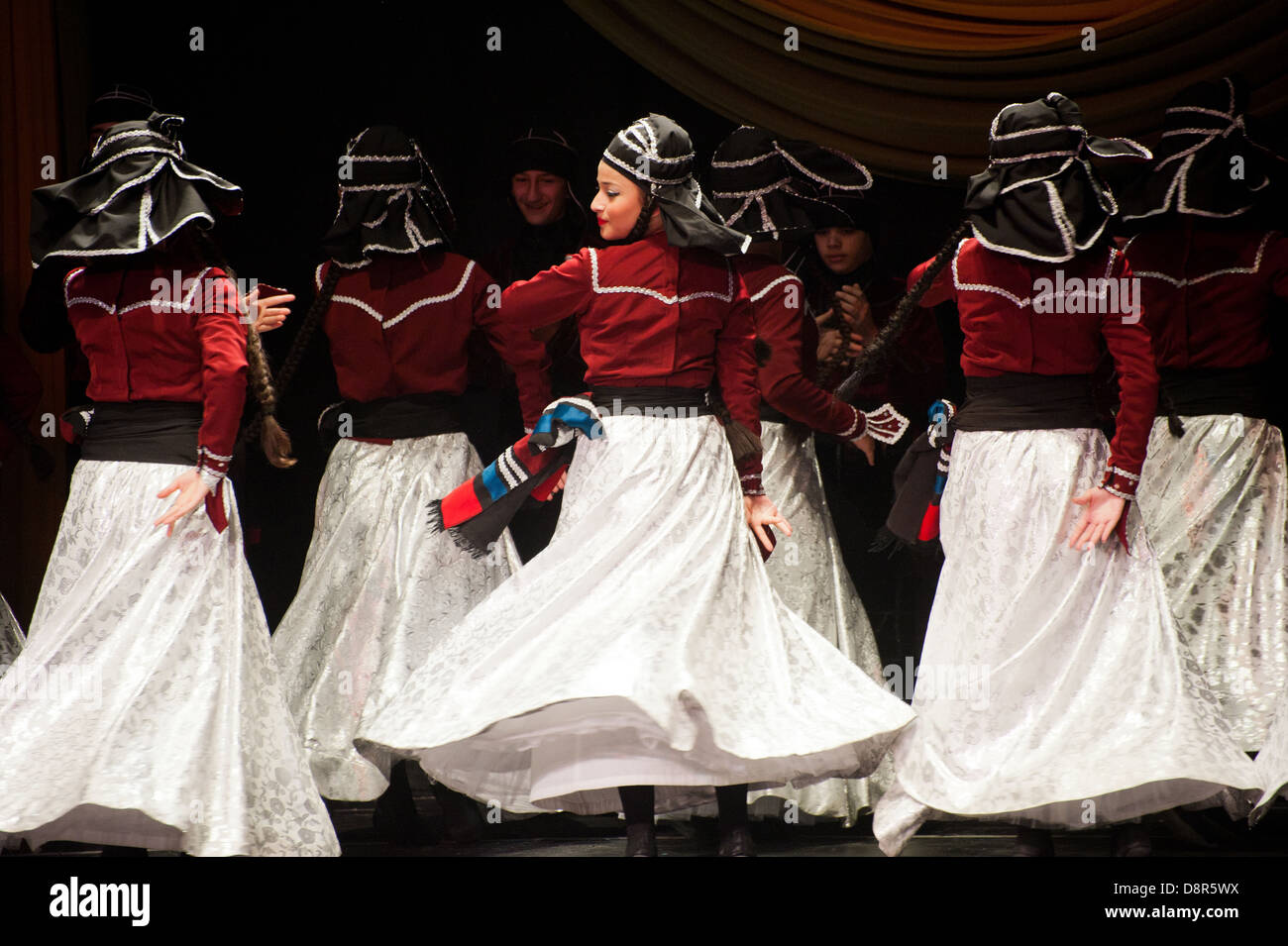 Georgian children dressed with traditional costumes dancing a folklore ...