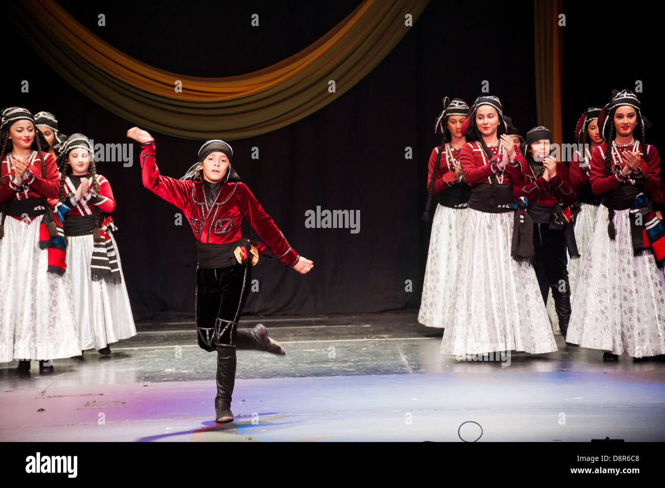 Georgian children dressed with traditional costumes dancing a folklore ...