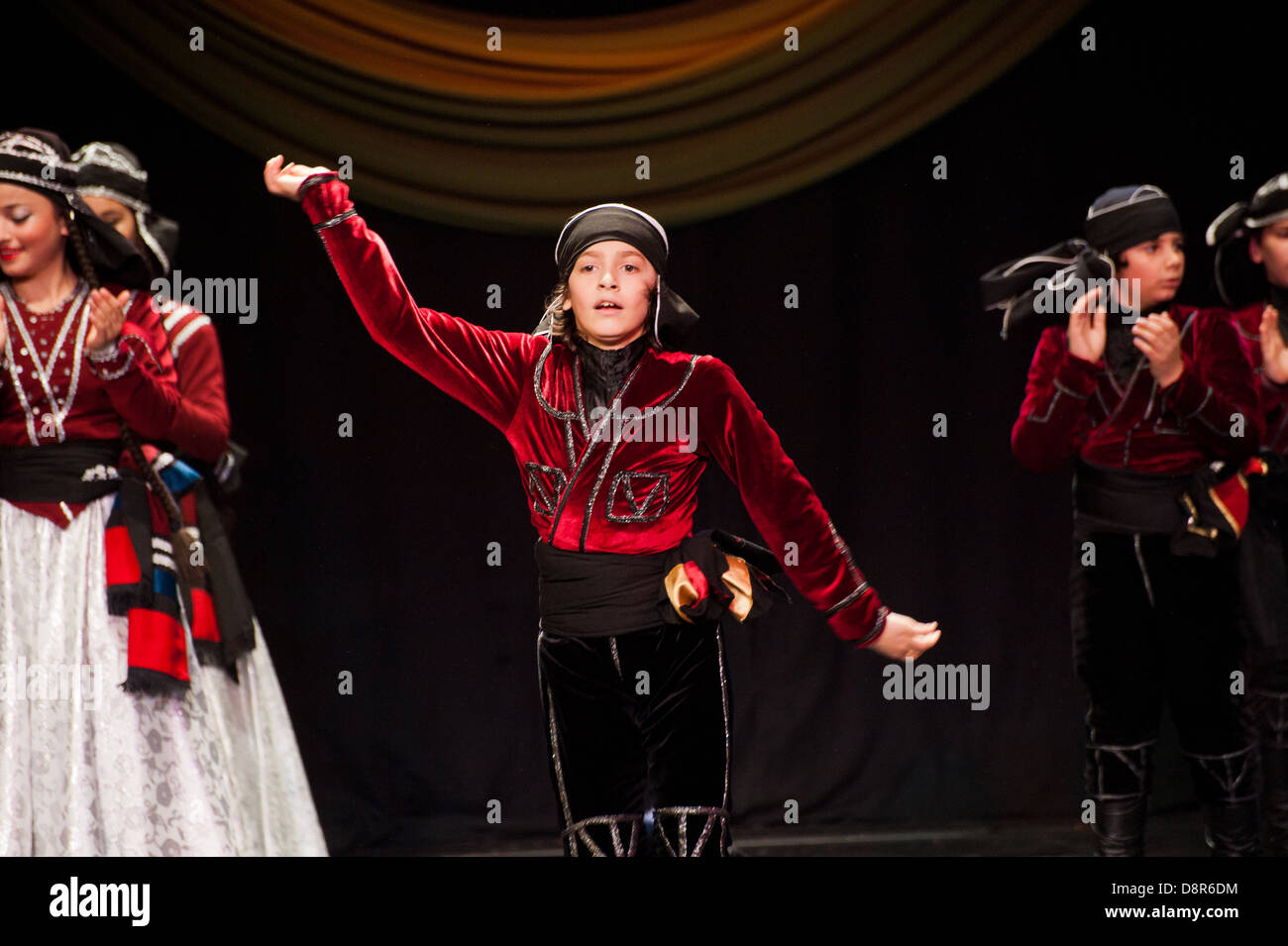 Georgian children dressed with traditional costumes dancing a folklore ...