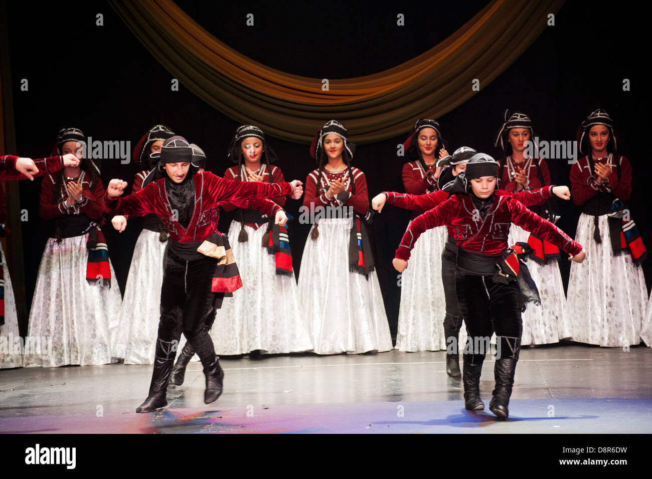 Georgian children dressed with traditional costumes dancing a folklore ...
