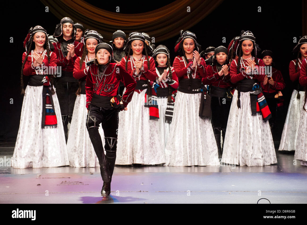 Georgian children dressed with traditional costumes dancing a folklore ...