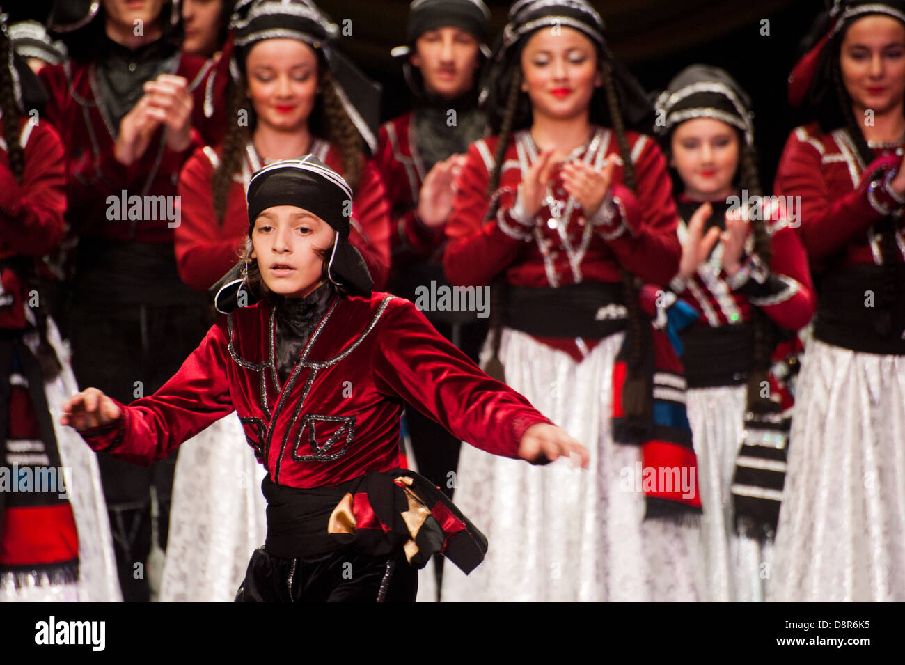 Georgian children dressed with traditional costumes dancing a folklore ...
