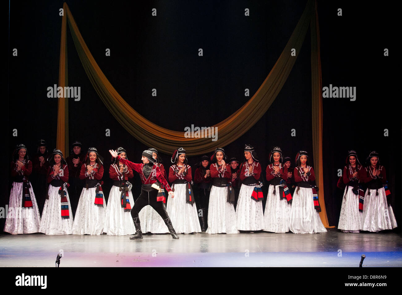 Georgian children dressed with traditional costumes dancing a folklore ...
