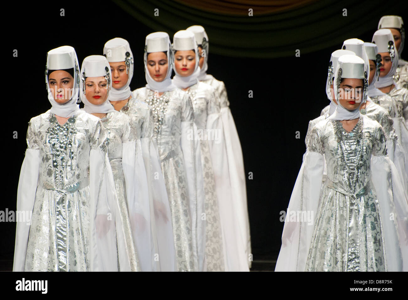 Georgian children dressed with traditional costumes dancing a folklore ...