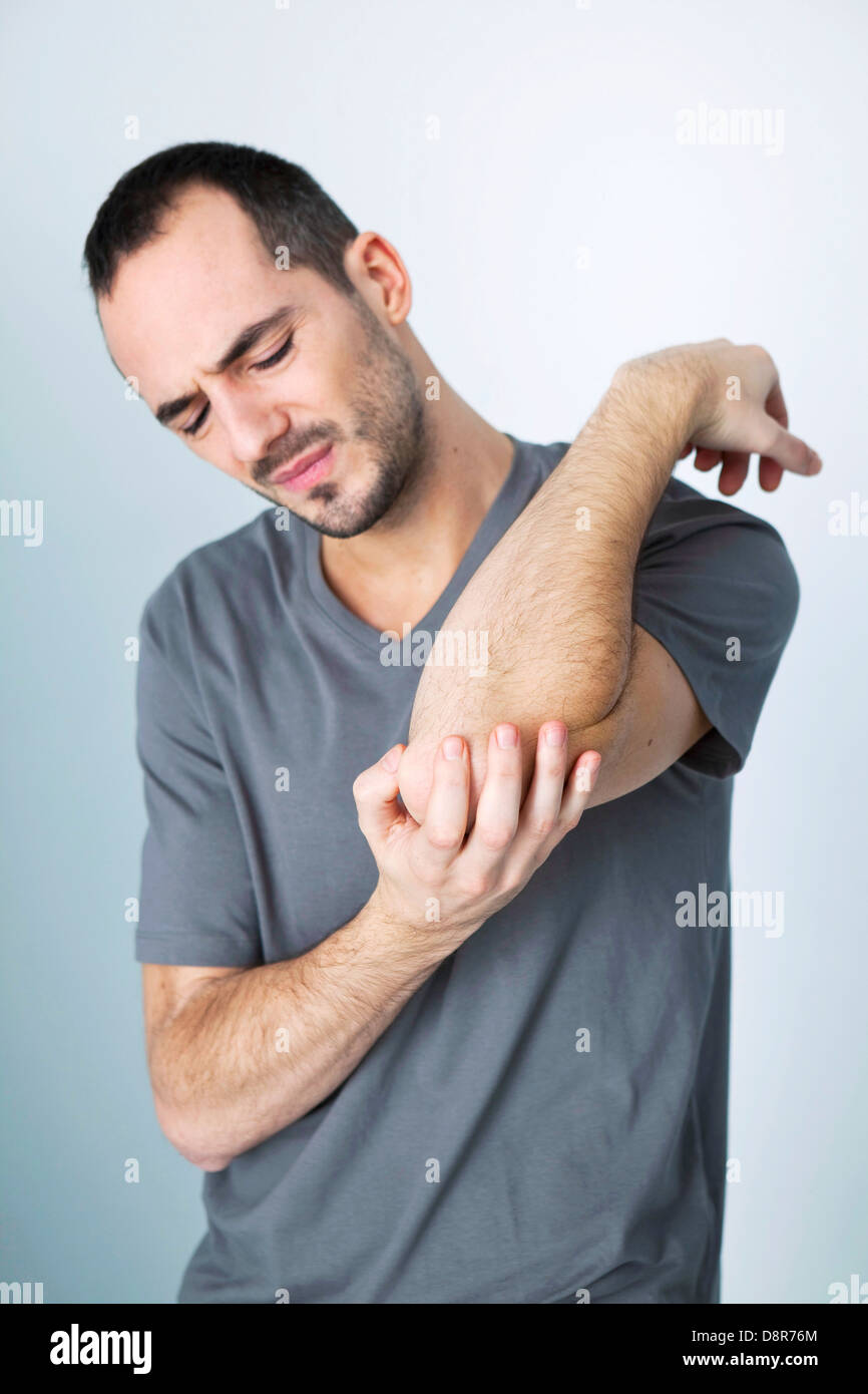 MAN WITH PAINFUL ELBOW Stock Photo - Alamy