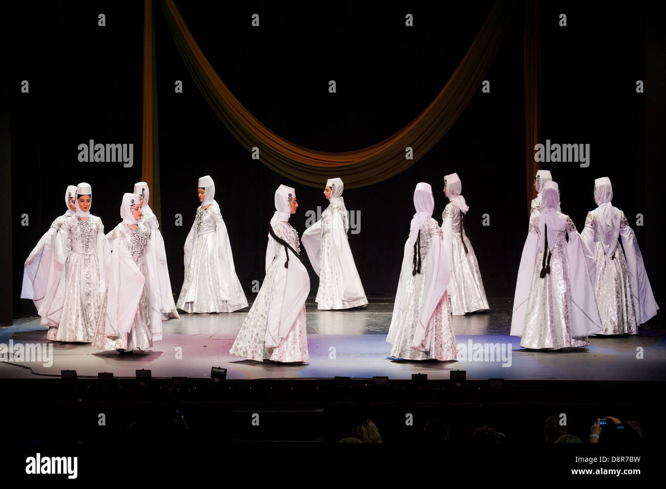 Georgian children dressed with traditional costumes dancing a folklore ...