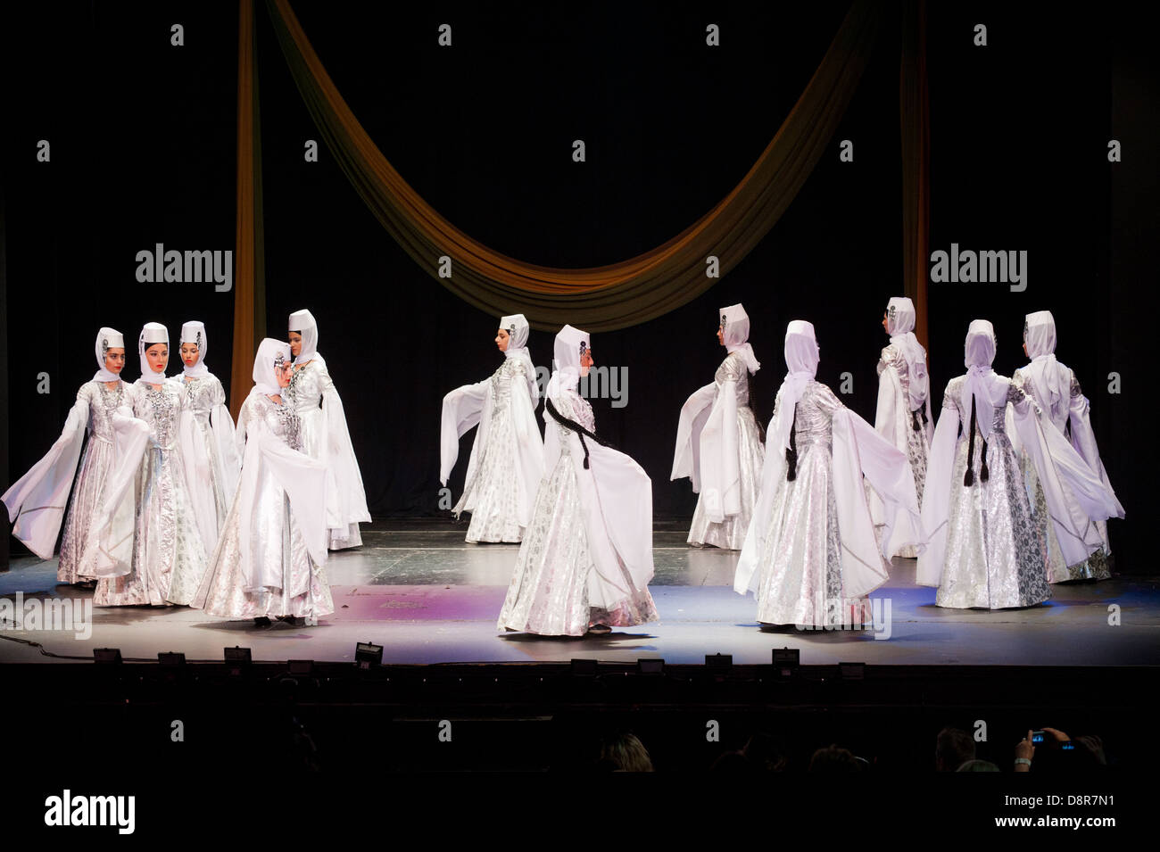Georgian children dressed with traditional costumes dancing a folklore ...