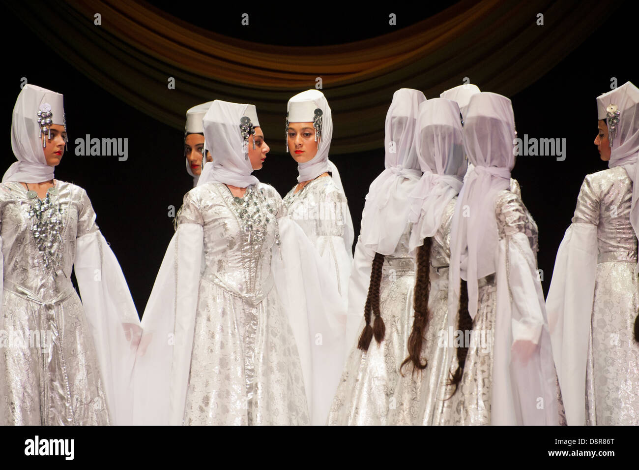Georgian children dressed with traditional costumes dancing a folklore ...