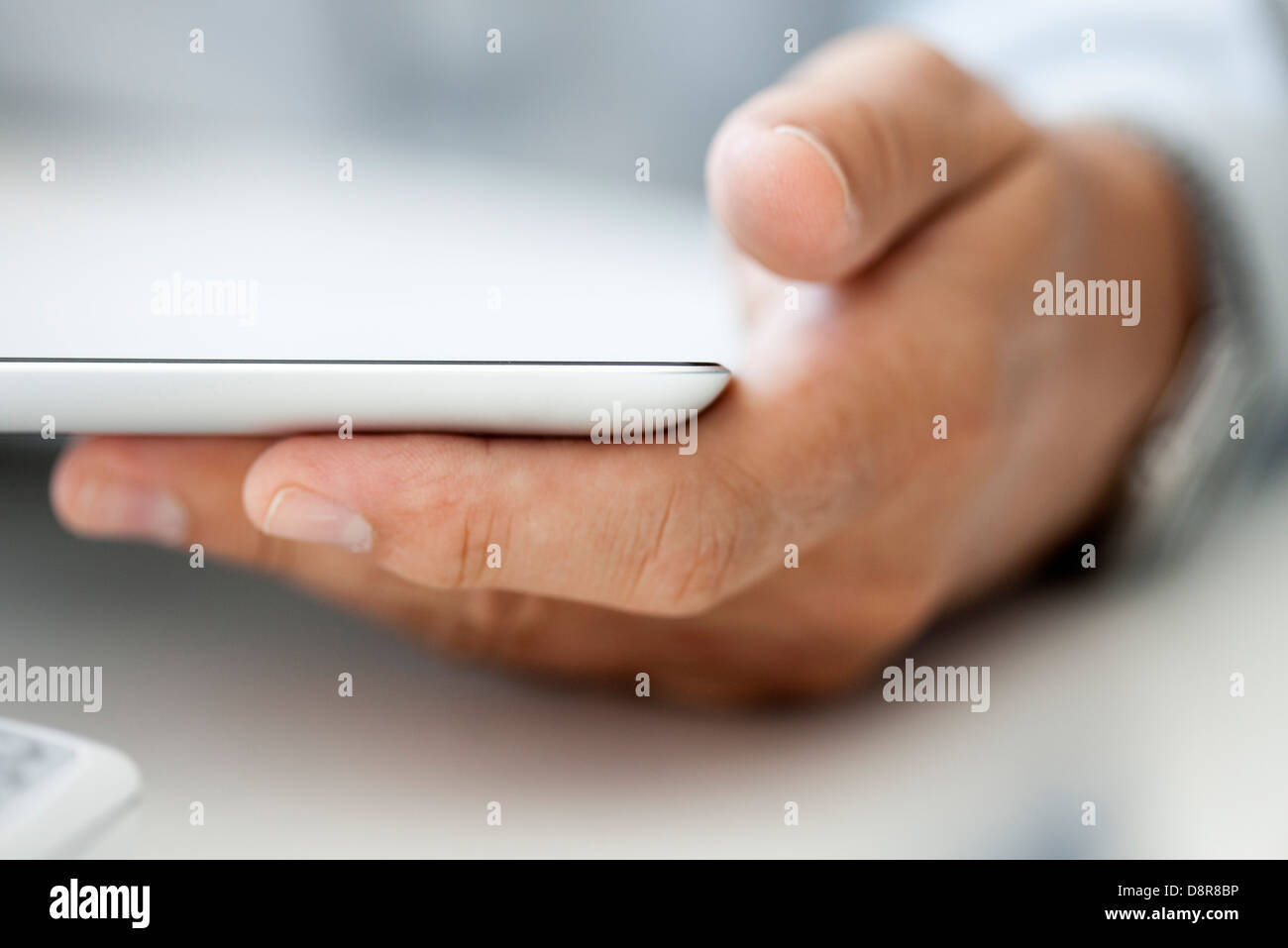 Man's hand holding digital tablet, close-up Stock Photo - Alamy