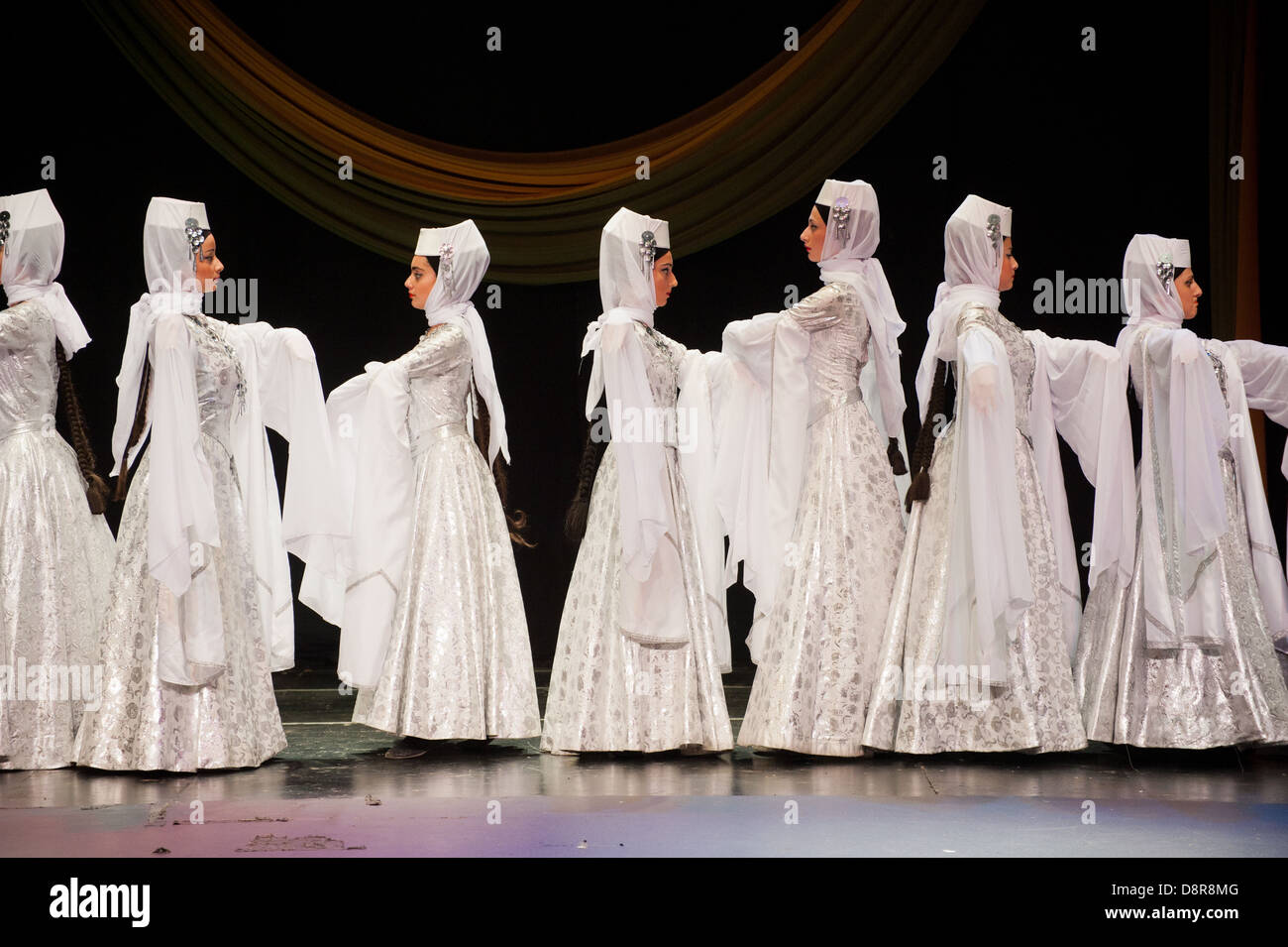 Georgian children dressed with traditional costumes dancing a folklore ...