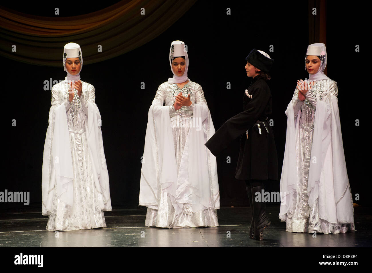 Georgian children dressed with traditional costumes dancing a folklore ...