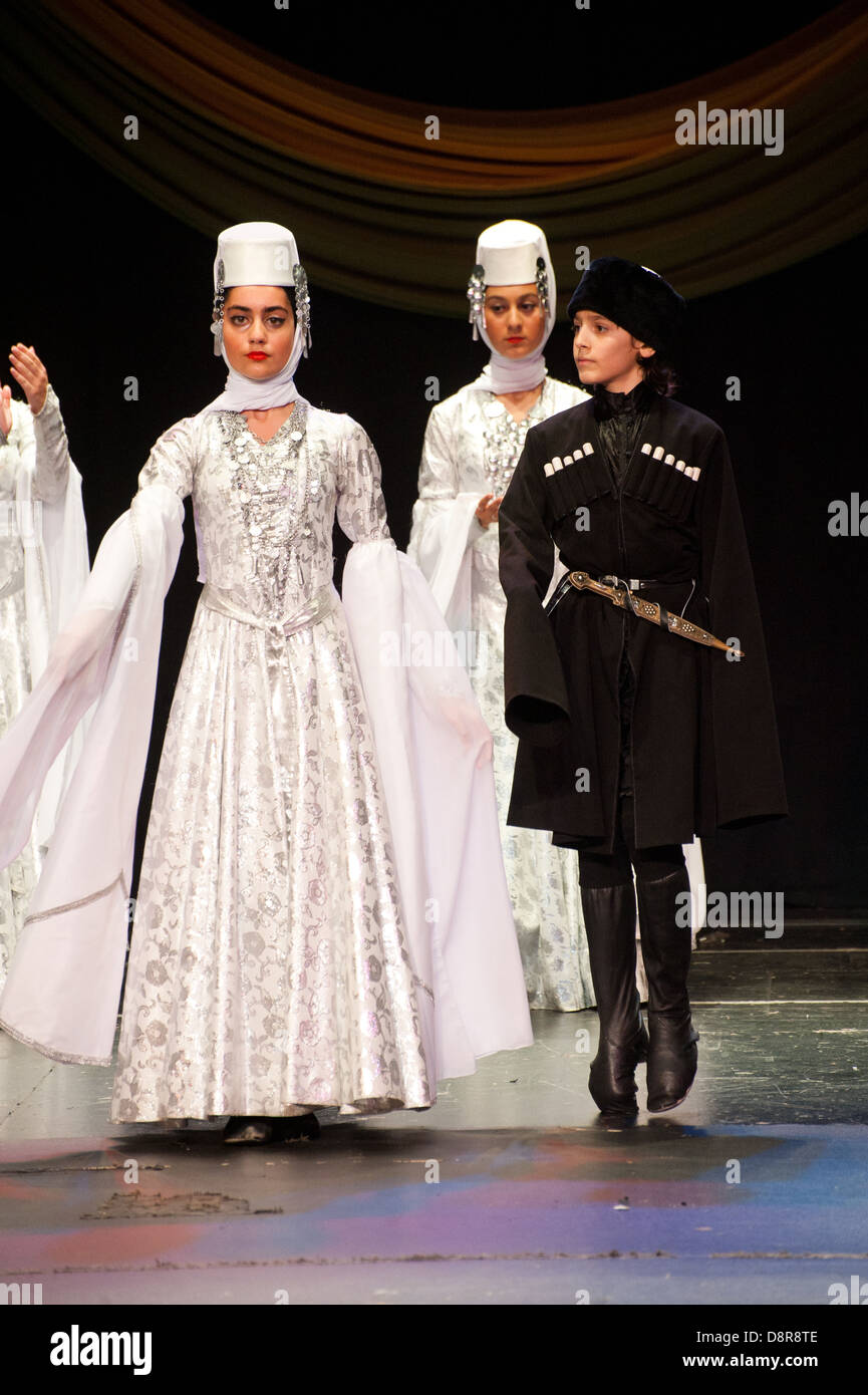 Georgian children dressed with traditional costumes dancing a folklore ...