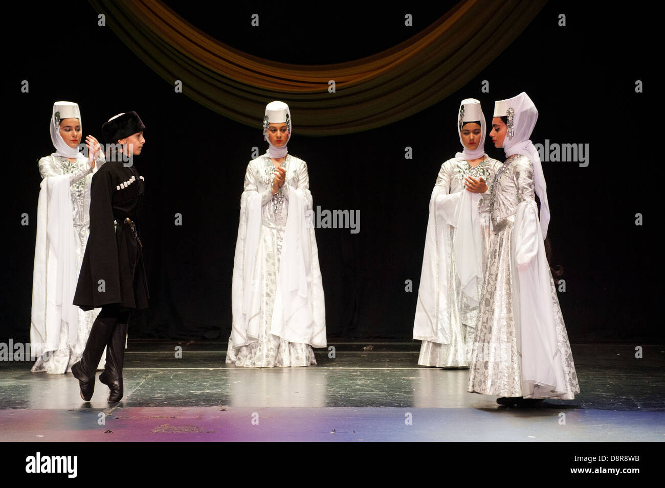 Georgian children dressed with traditional costumes dancing a folklore ...