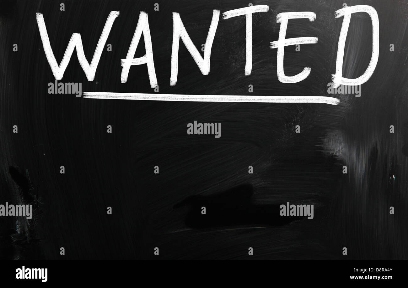 Wanted handwritten with white chalk on a blackboard Stock Photo - Alamy