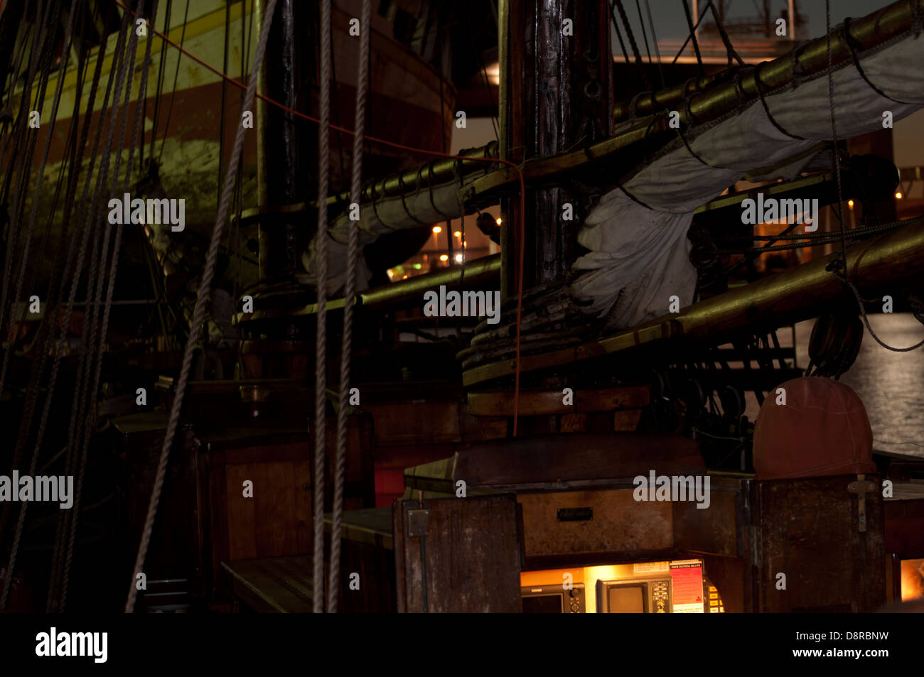 clipper sailing ship moody night light with city lights background ...