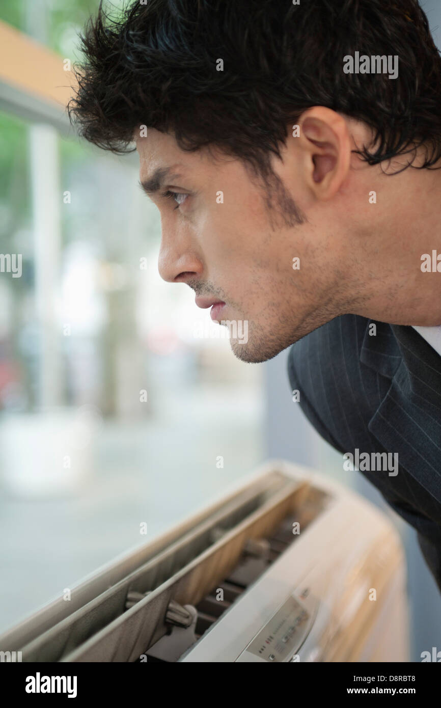 Businessman looking out of window, side view Stock Photo - Alamy