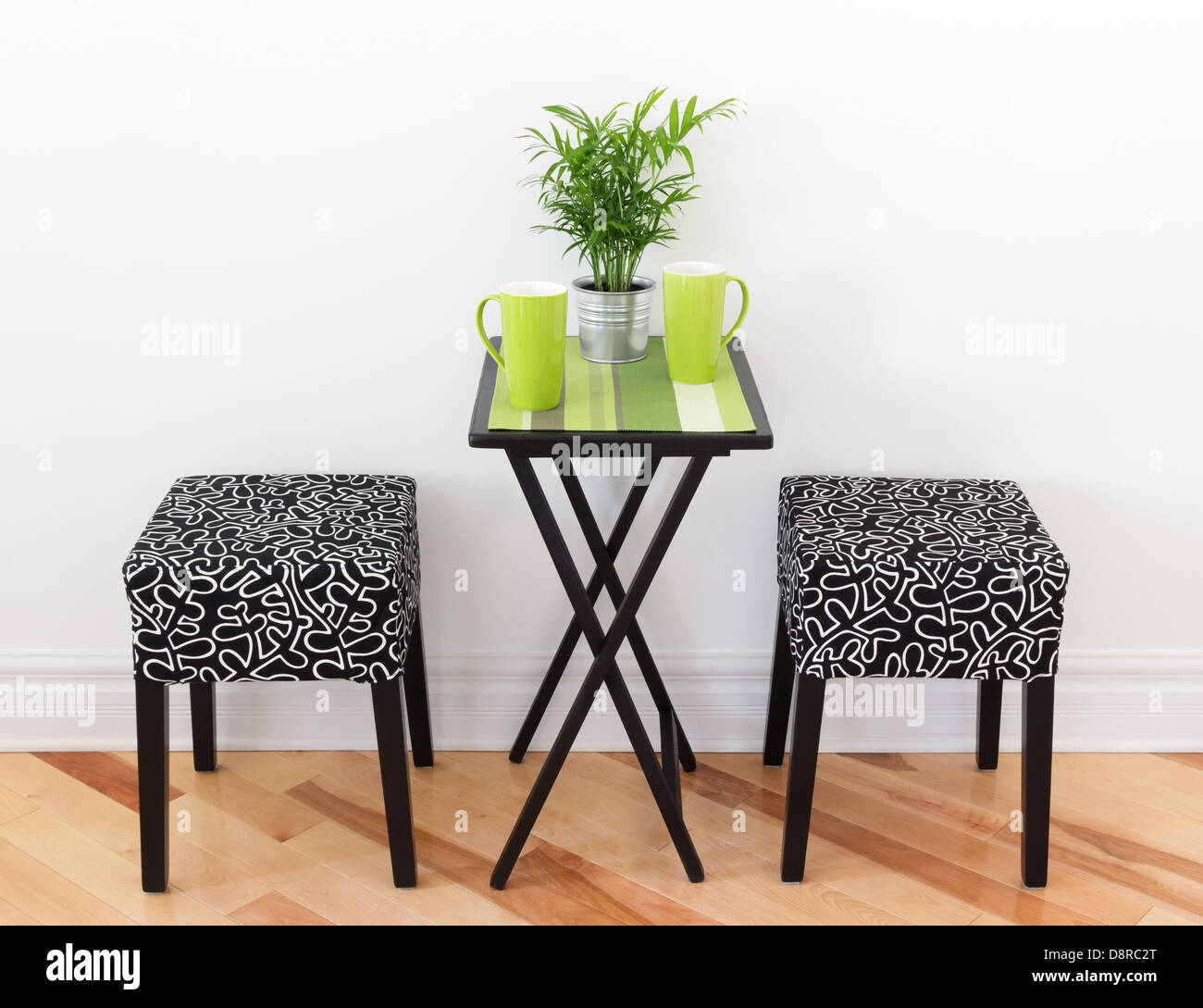 Table for two with green cups, decorated with plant Stock Photo - Alamy