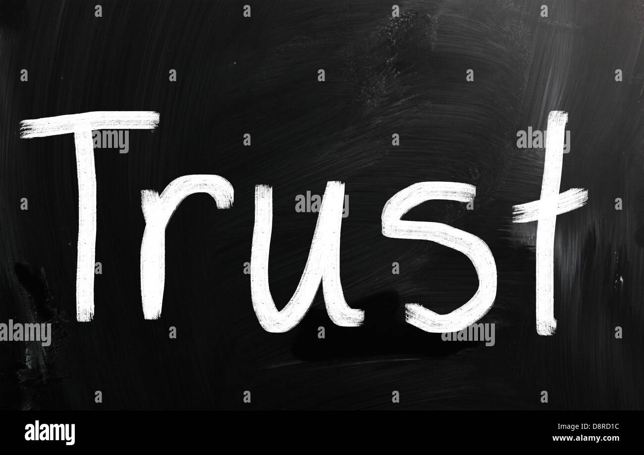 The word "Trust" handwritten with white chalk on a blackboard Stock ...
