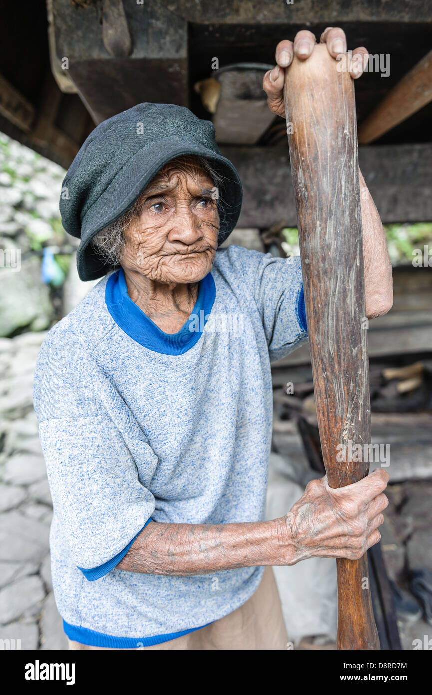 Woman pounding rice in a rural village, Batad, Luzon, Philippines Stock ...