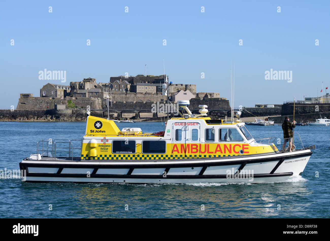 Guernsey marine ambulance in St Peter Port Harbour overlooked by Castle ...