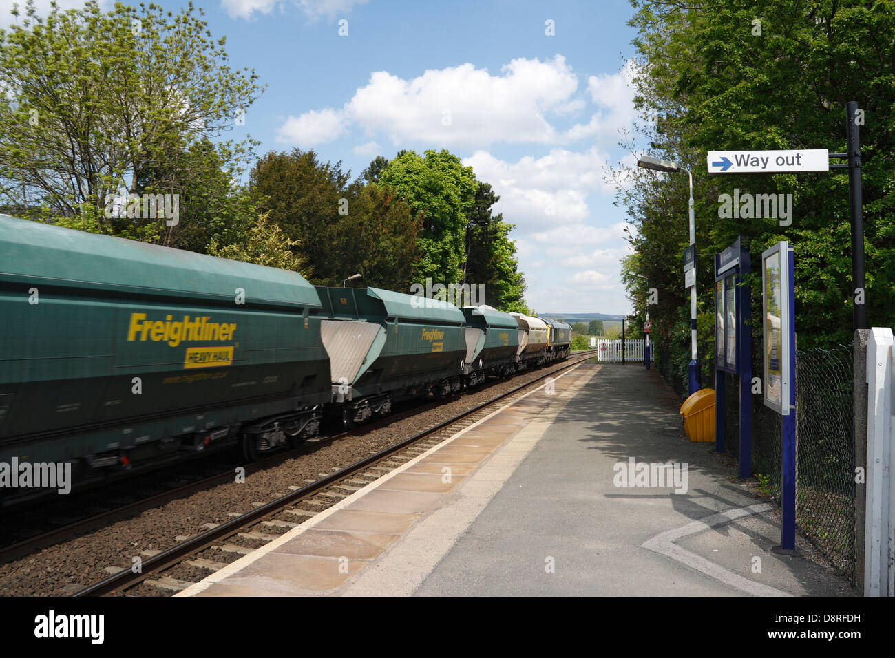 A freight train passing through Edale railway station platform in the ...