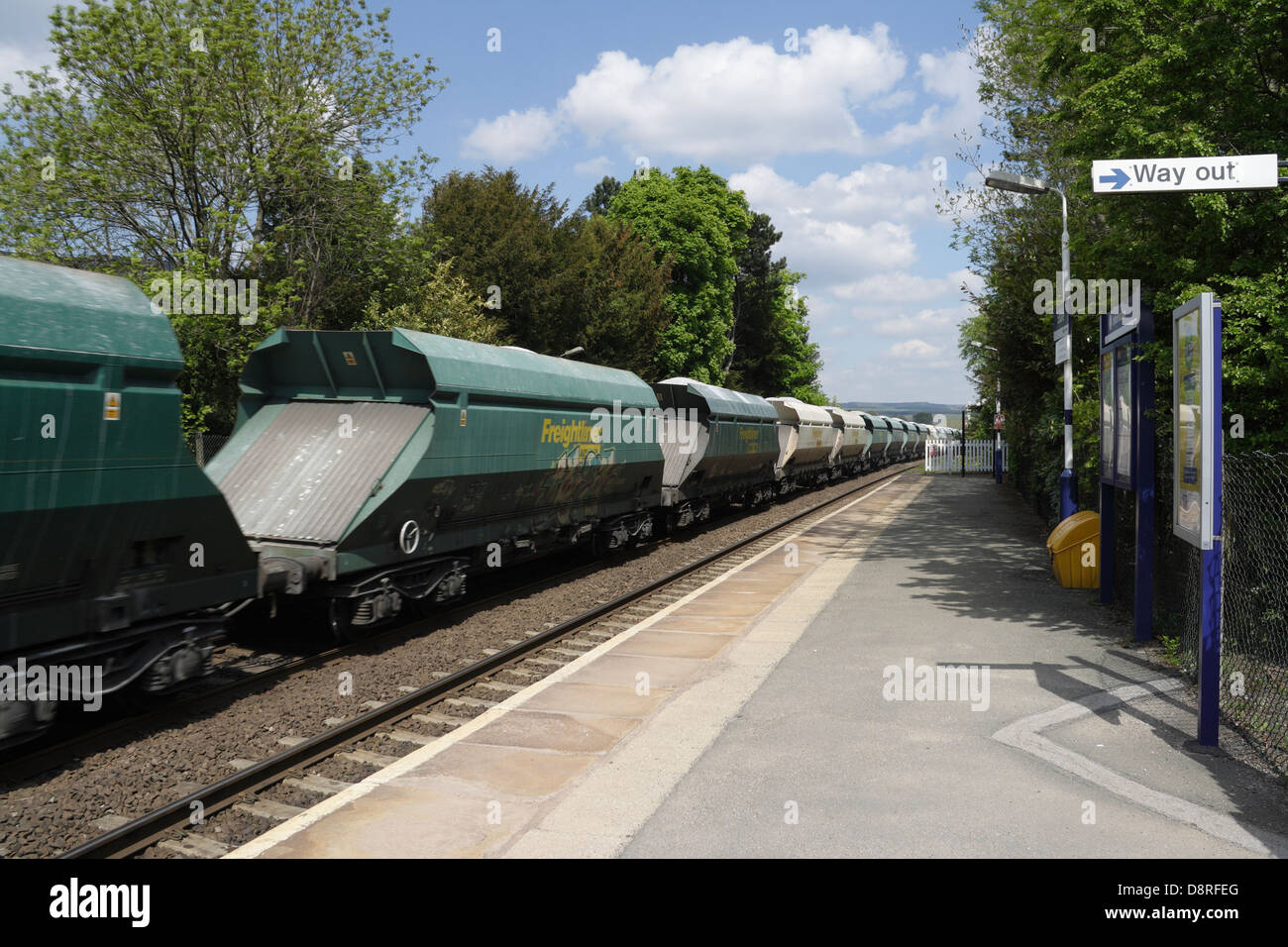 A freight train passing through Edale railway station in Derbyshire ...