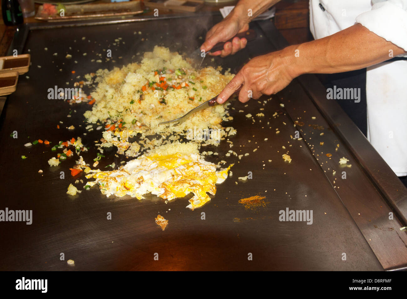Chef prepares rice on a griddle in a Japanese barbecue restaurant Stock ...