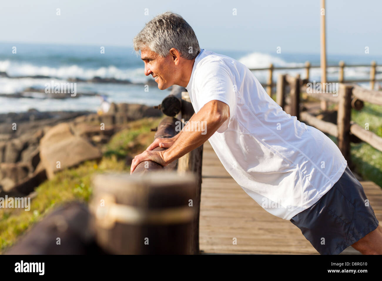 fit senior man exercising at the beach in the morning Stock Photo - Alamy