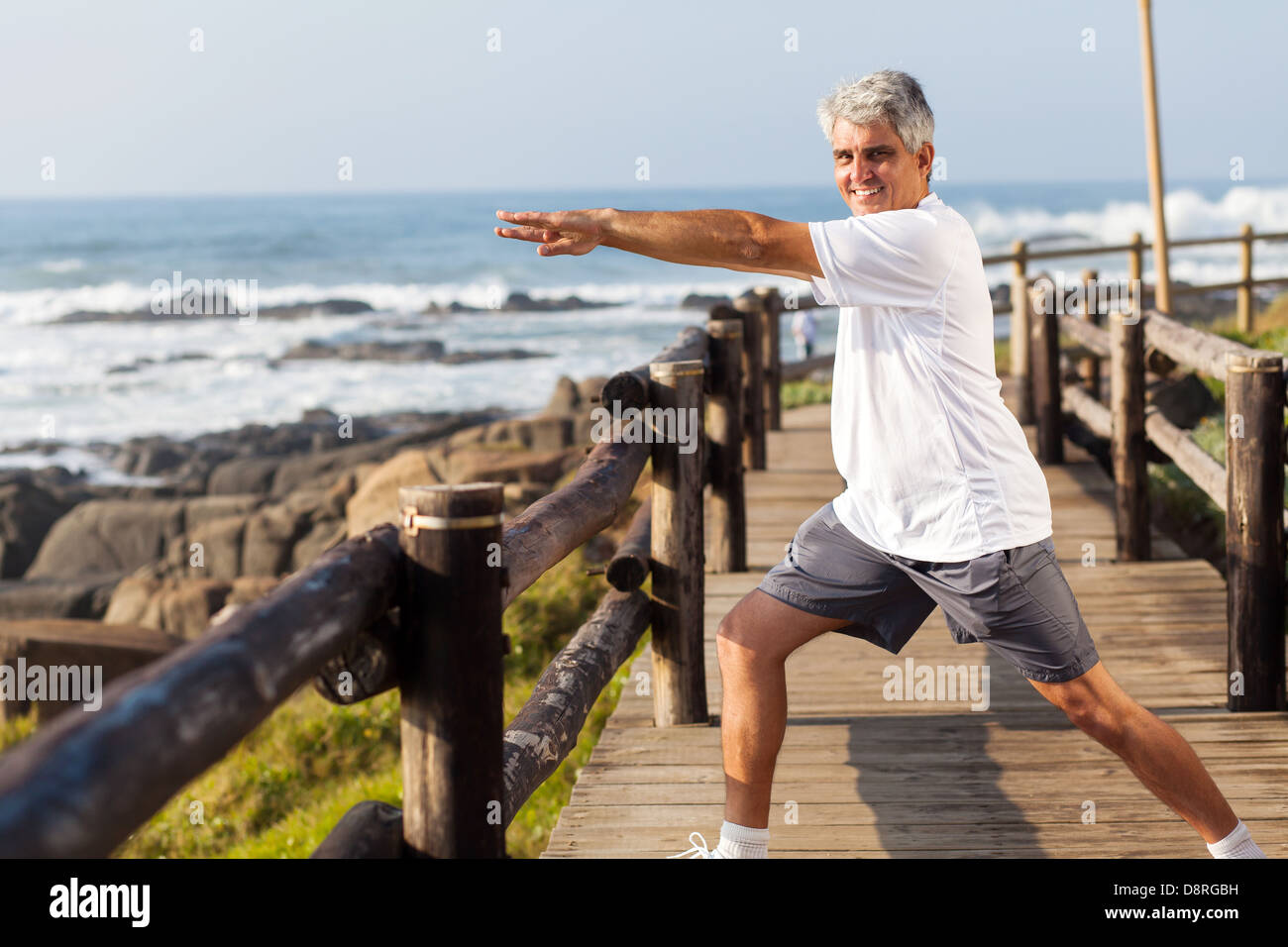 active middle aged man doing morning workout at the beach Stock Photo ...