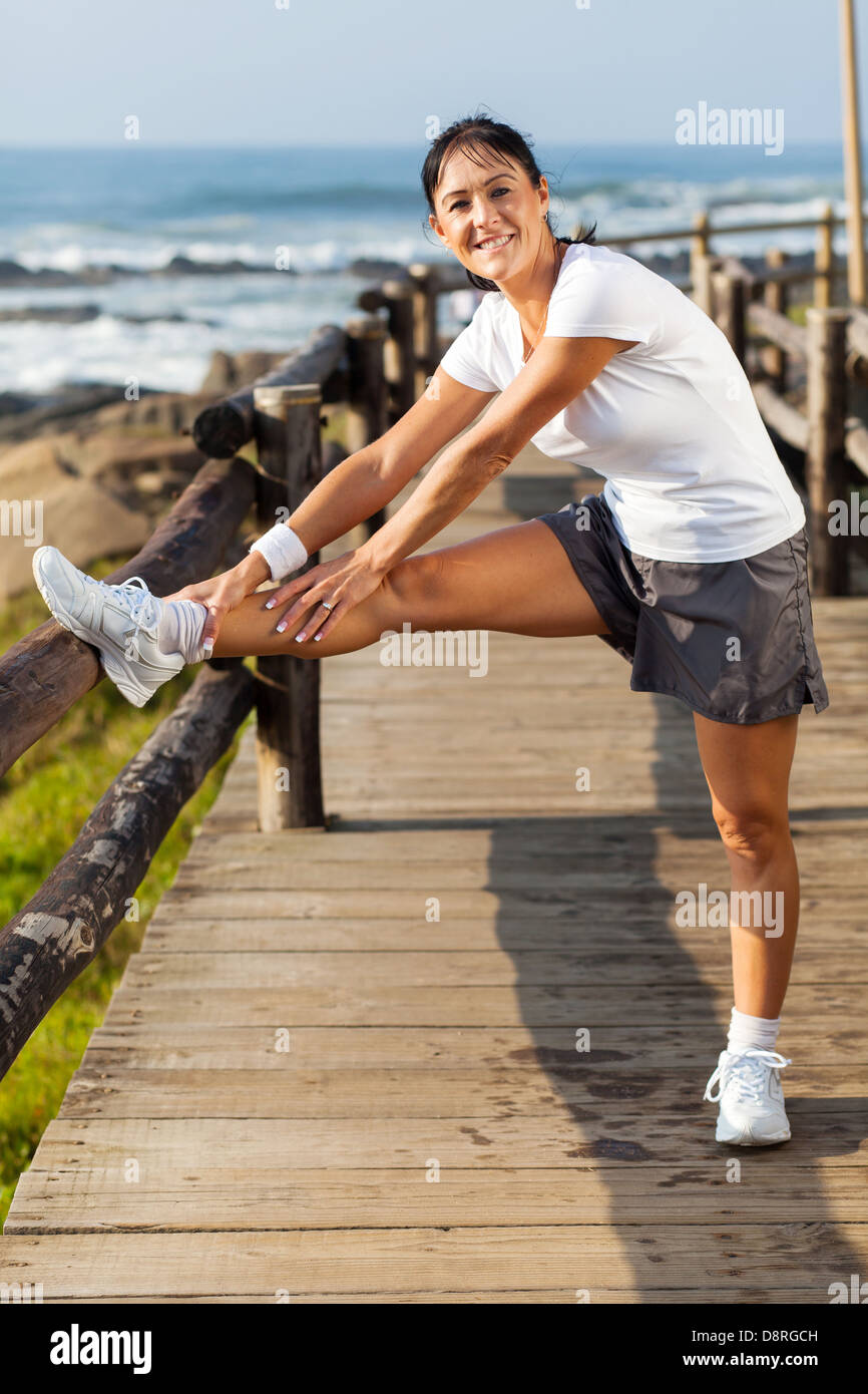 active middle aged woman doing morning exercise at the beach Stock ...