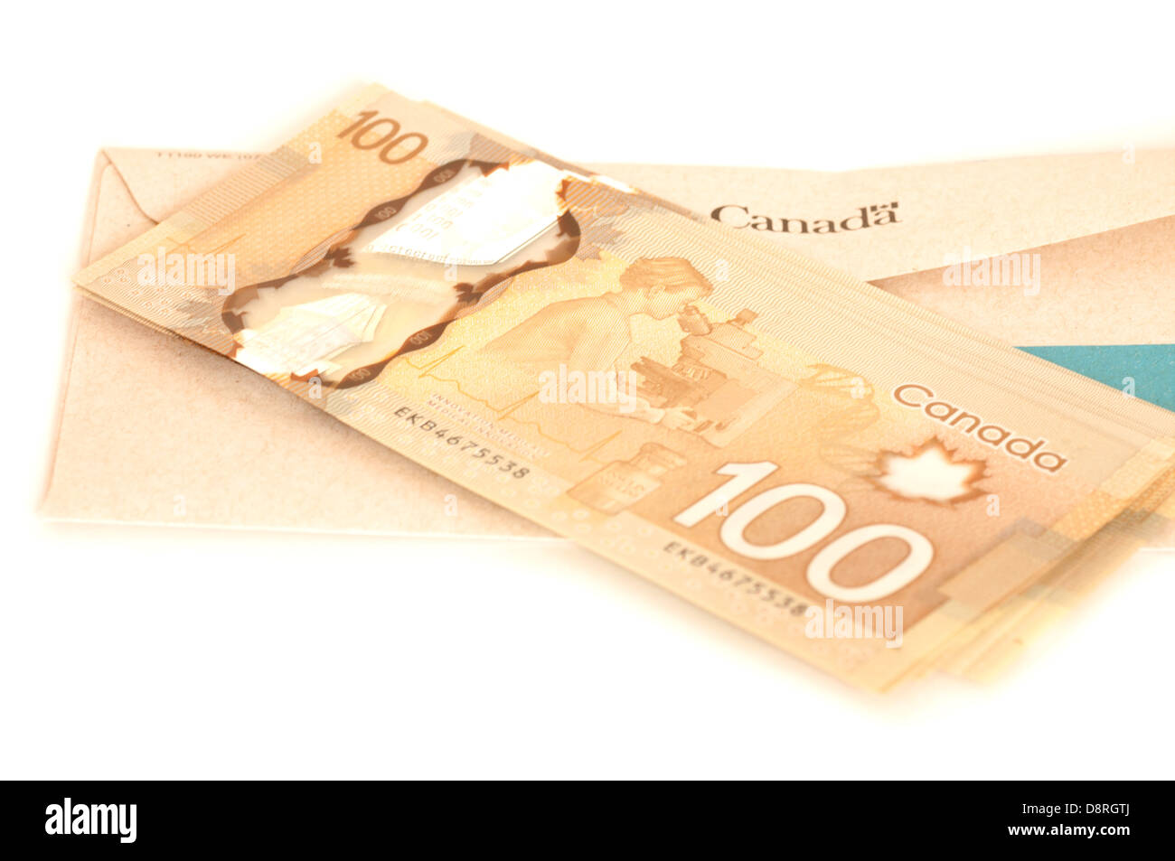 A series of 100 hundred Canadian dollars in brown envelop Stock Photo ...