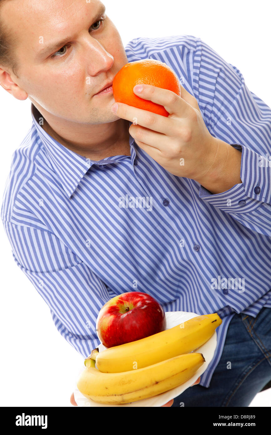 young man with fruits on white background concept of healthy nutrition ...