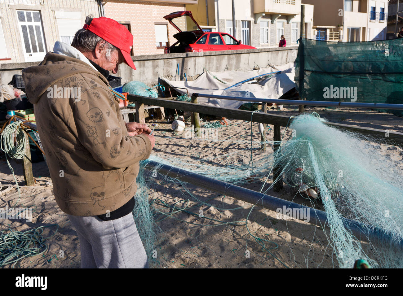 Fisherman fixing net, Aguda beach Vila Nova de Gaia Portugal Stock ...
