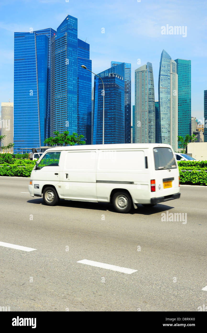 White minibus on the road in Singapore. Blurred motion Stock Photo - Alamy