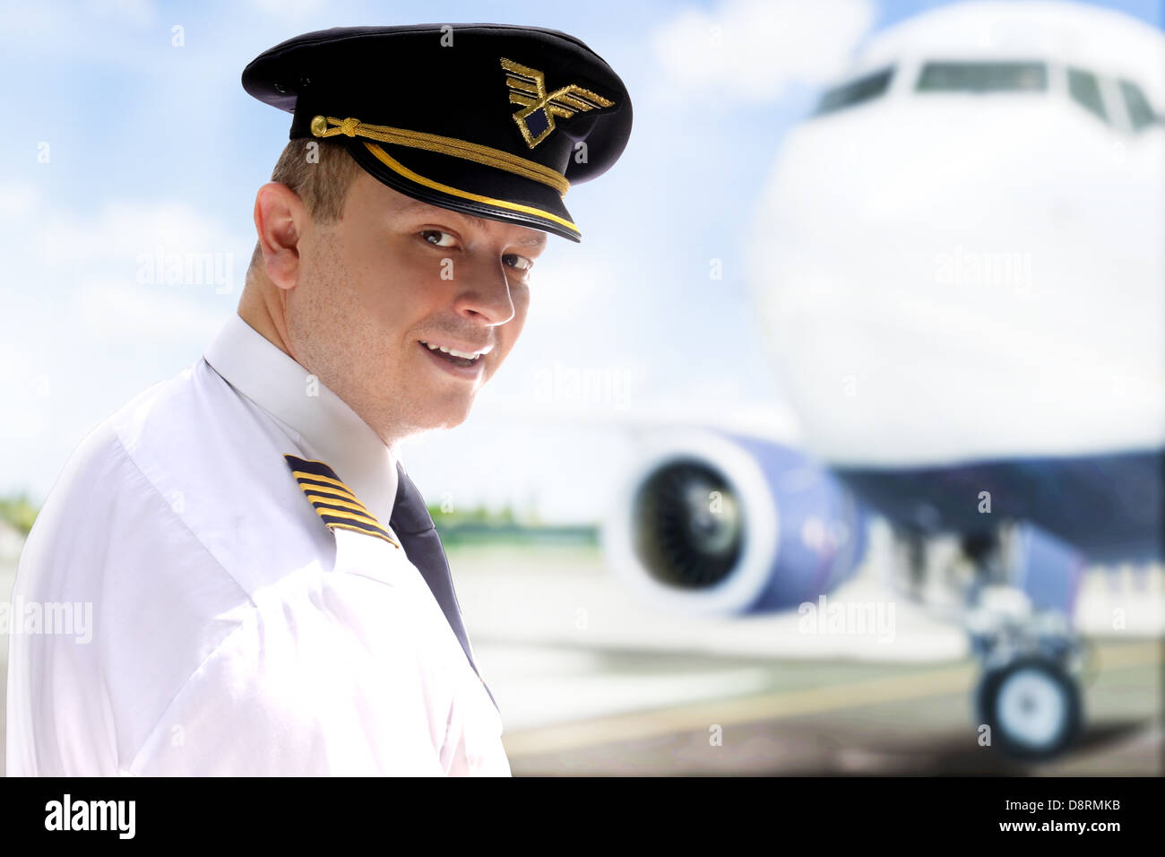 Smiling pilot goes into the plane Stock Photo - Alamy