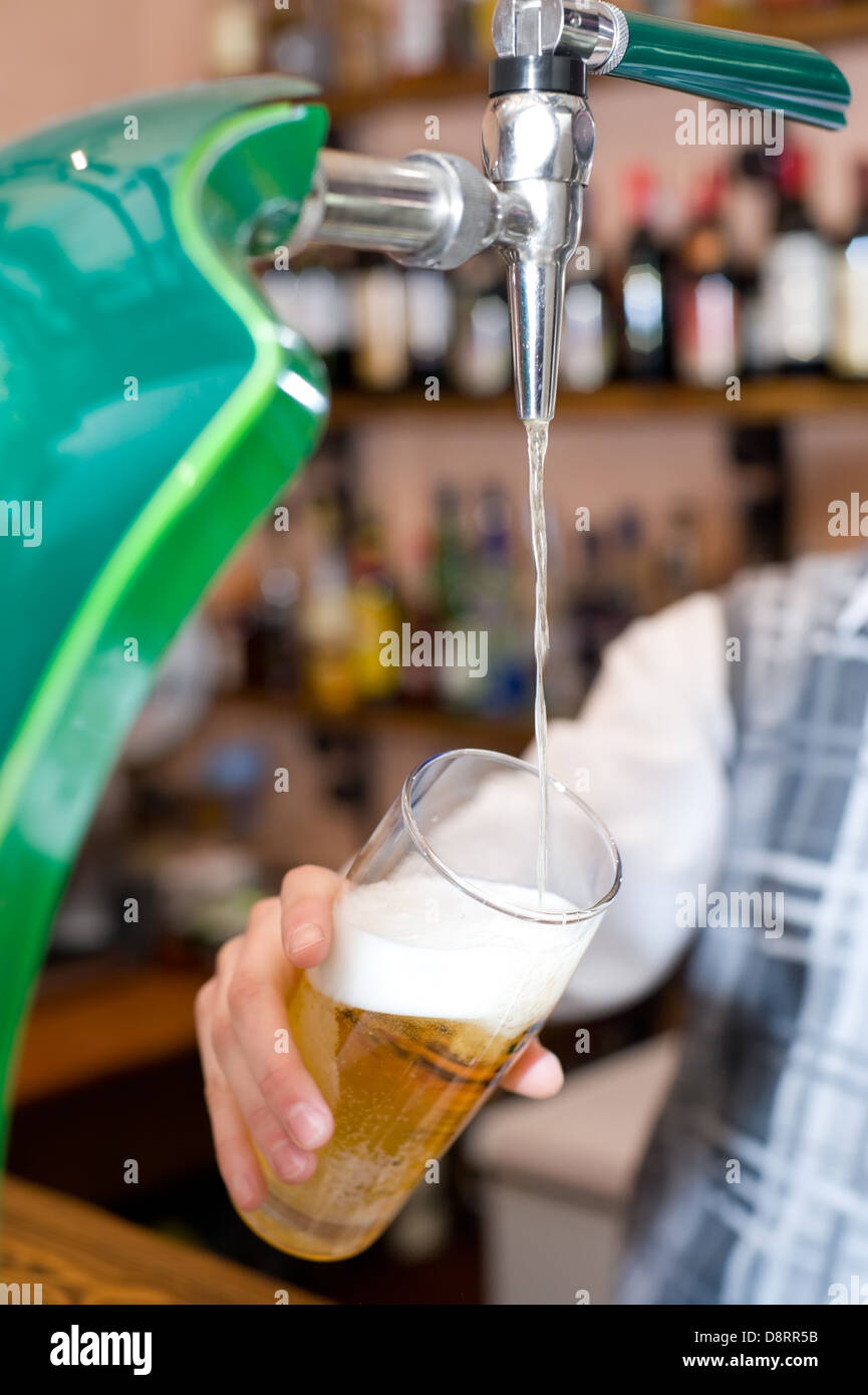 filling glass with beer from faucet Stock Photo - Alamy
