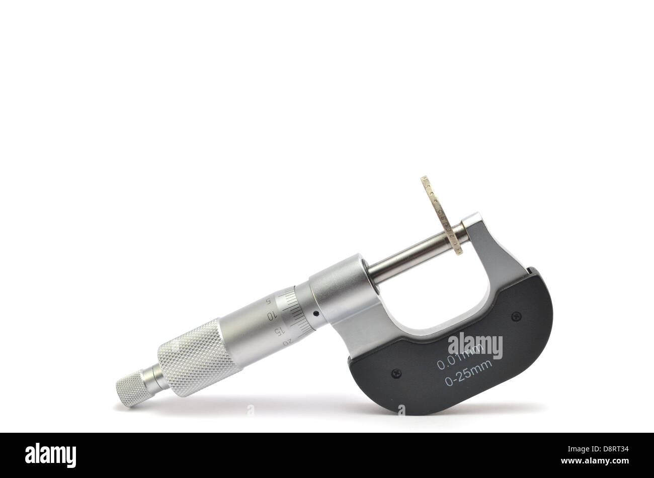 micrometer and coins lie on a white background Stock Photo - Alamy