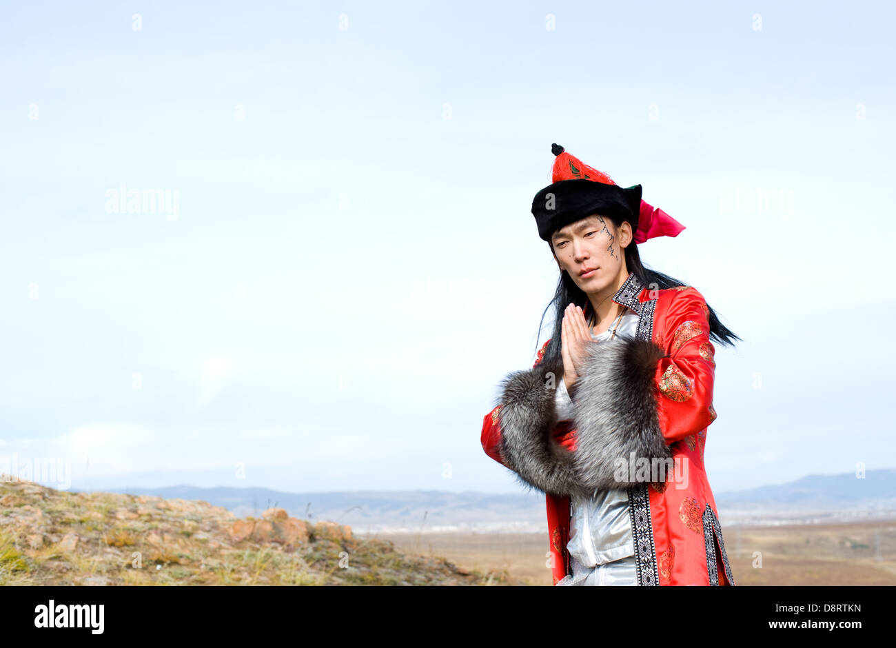 man in red Mongolian costume Stock Photo - Alamy