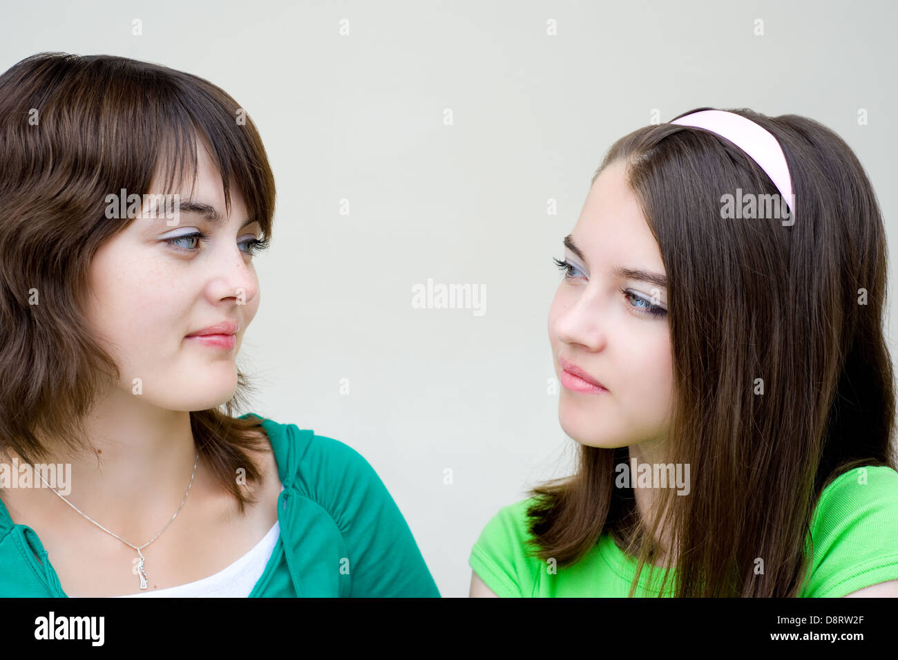 two beautiful girls look at each other Stock Photo - Alamy