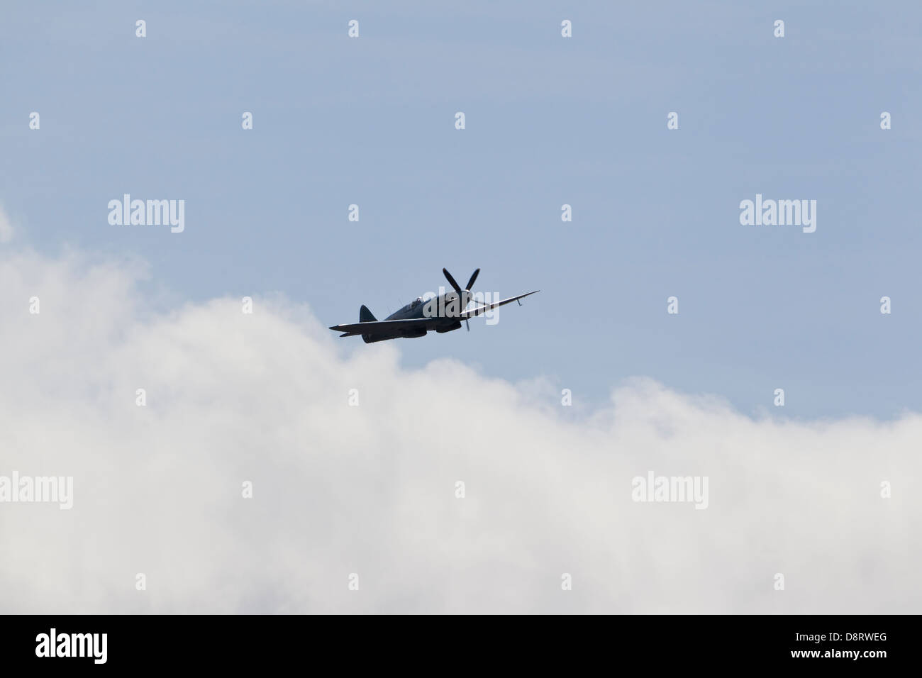 Supermarine Spitfire single seater fighter aircraft flying in cloudy ...