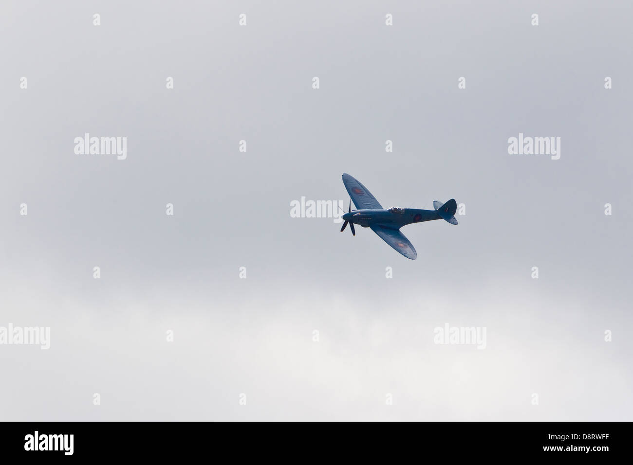 Supermarine Spitfire single seater fighter aircraft flying in cloudy ...